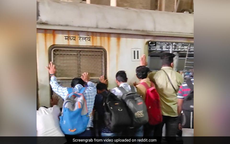 Mumbai commuters push train to rescue man trapped underneath